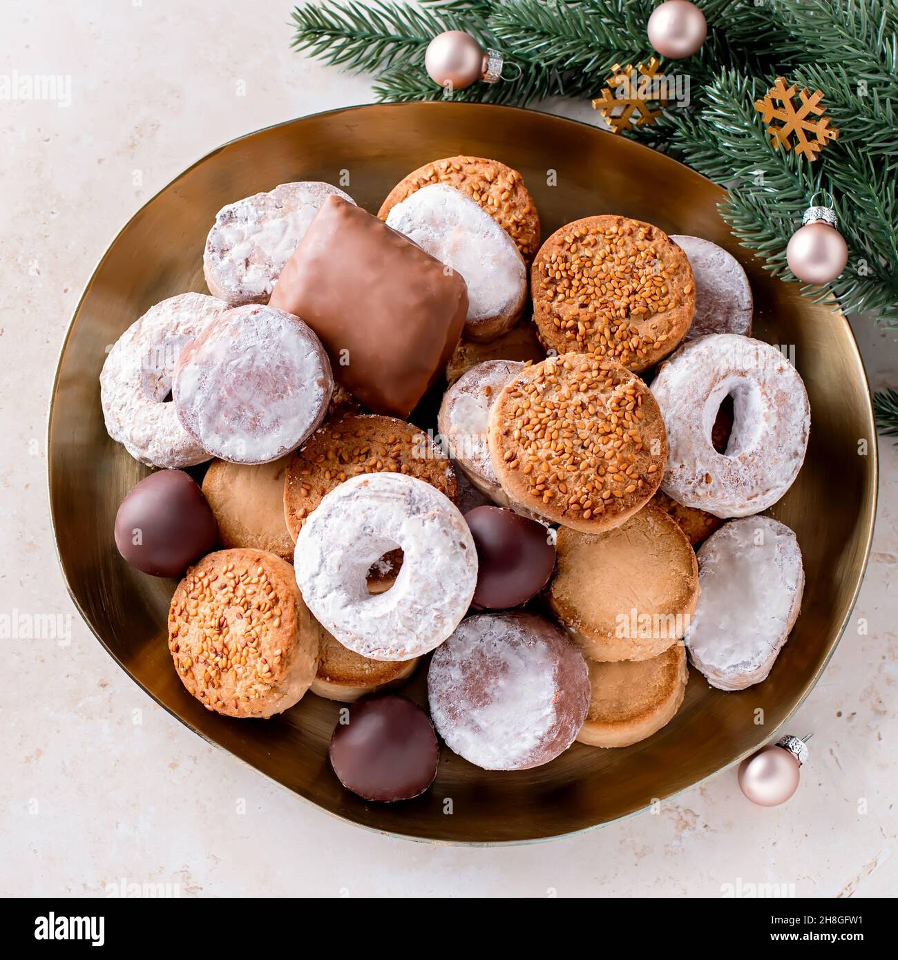 Holiday delicacies polvorones and mantecados in golden plate on beige ...