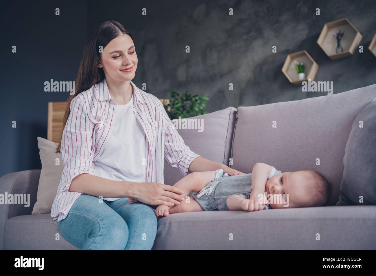 Portrait of attractive careful gentle cute cheerful mom playing with ...