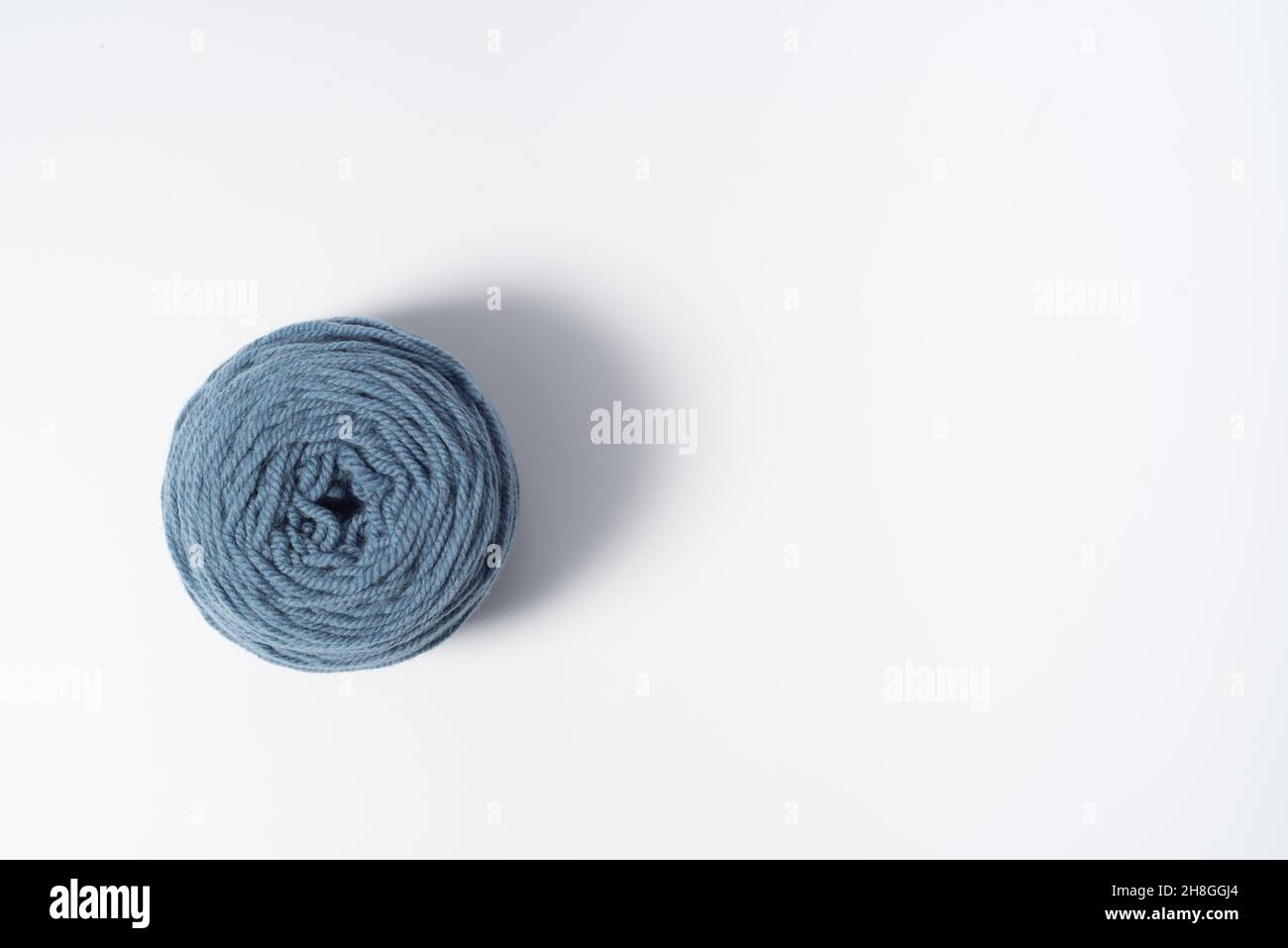 Large light blue ball of yarn on white background Stock Photo - Alamy