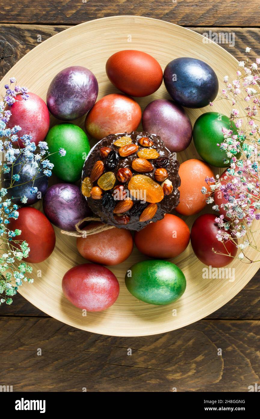 Easter cake with dried fruits and nuts on a large wooden plate with ...