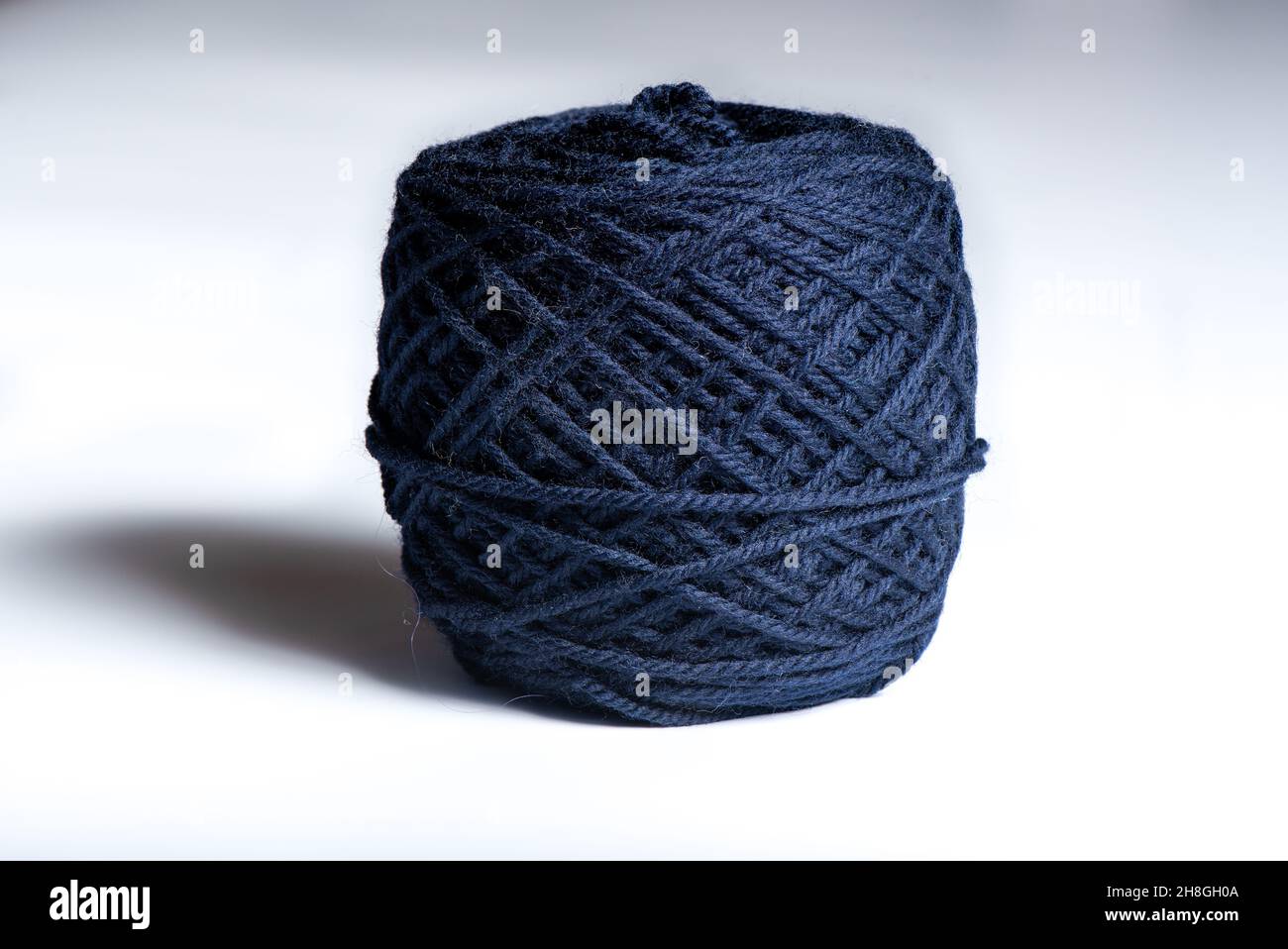 Ball of dark blue yarn on a white background Stock Photo - Alamy
