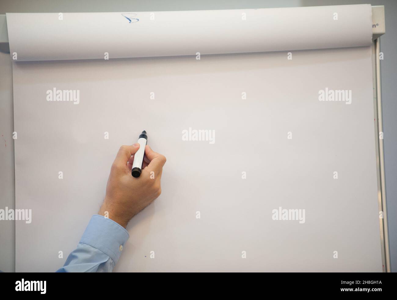 Business whiteboard. Hand with a marker writing on a business ...