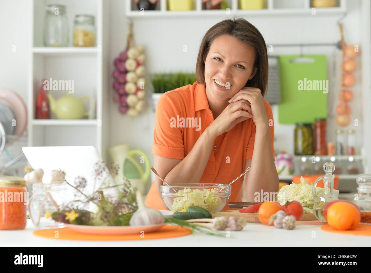 Portrait of beautiful young woman cooking in kitchen Stock Photo - Alamy