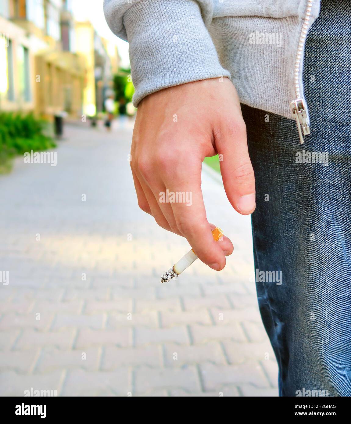 Person with Cigarette on the City Street Stock Photo - Alamy