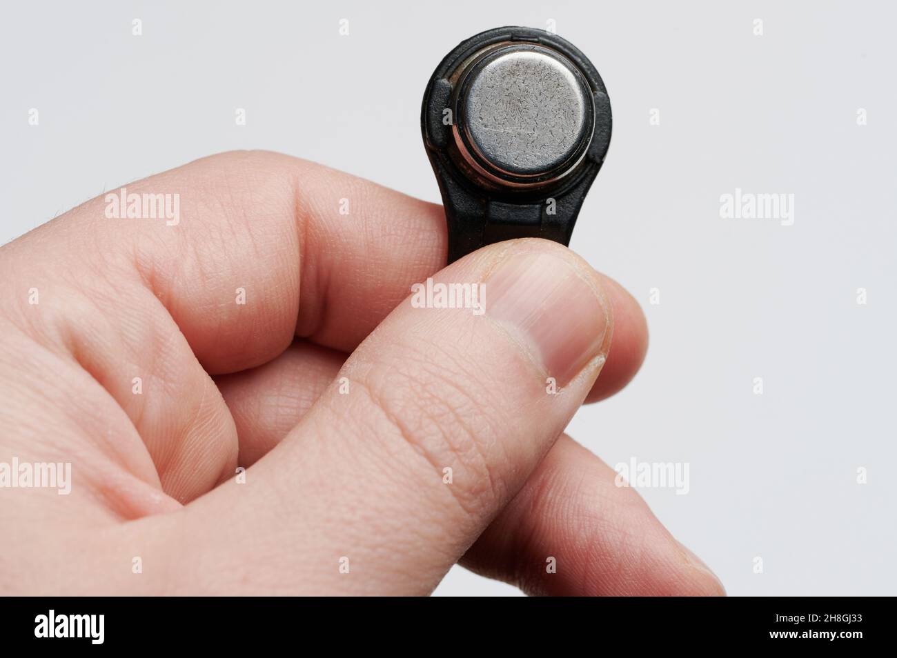 Hand hold round magnet key isolated on studio background Stock Photo ...