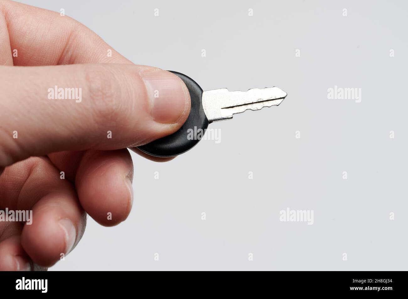 Little key in hand isolated on studio background macro view Stock Photo ...