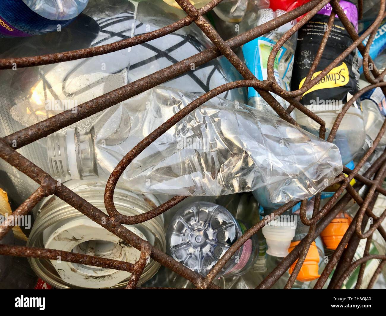 Waste plastic bottles piled up in metal bales. Plastic waste for ...