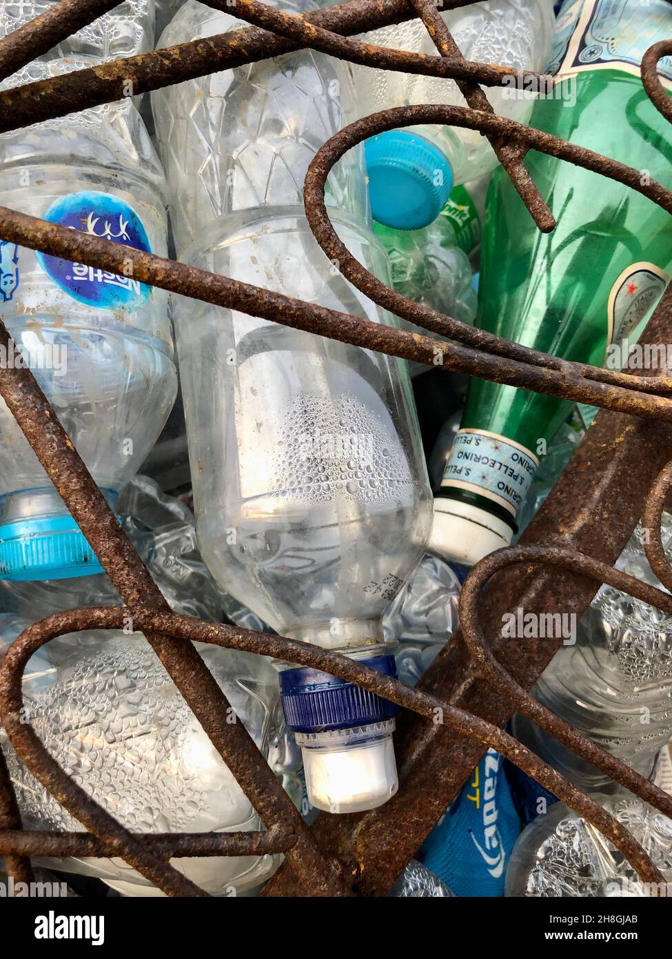 Waste plastic bottles piled up in metal bales. Plastic waste for ...