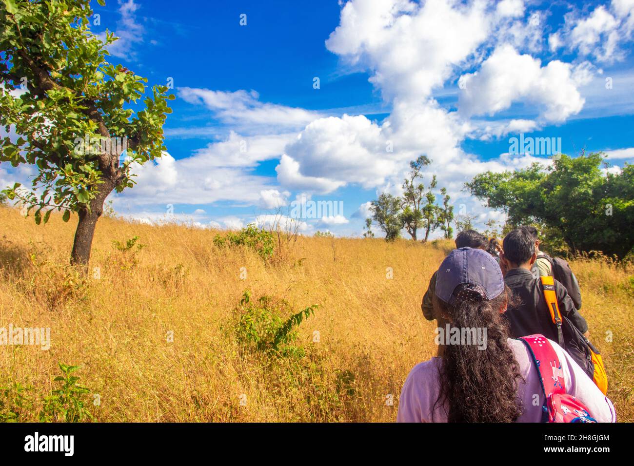 Group of hikers climbing a desolate brown mountain. Irshalgad fort ...