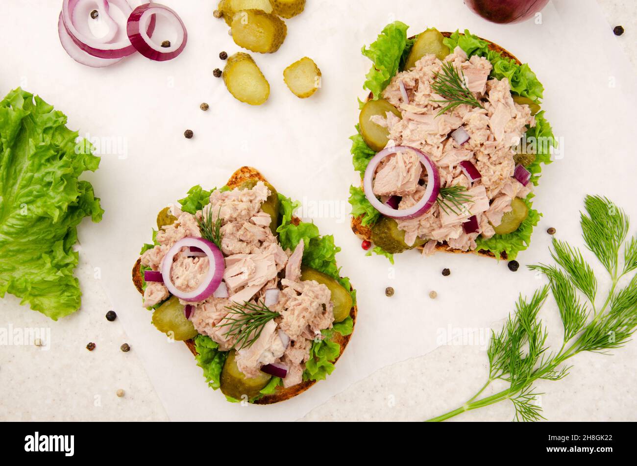 Flat lay view at Tuna sandwiches with lettuce tomatoes pickles and ...