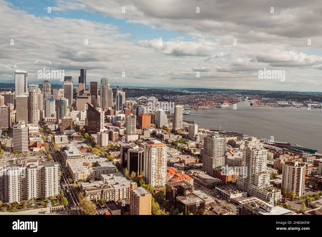 Aerial view of Seattle skyscrapers and port with clouds and blue sky on ...