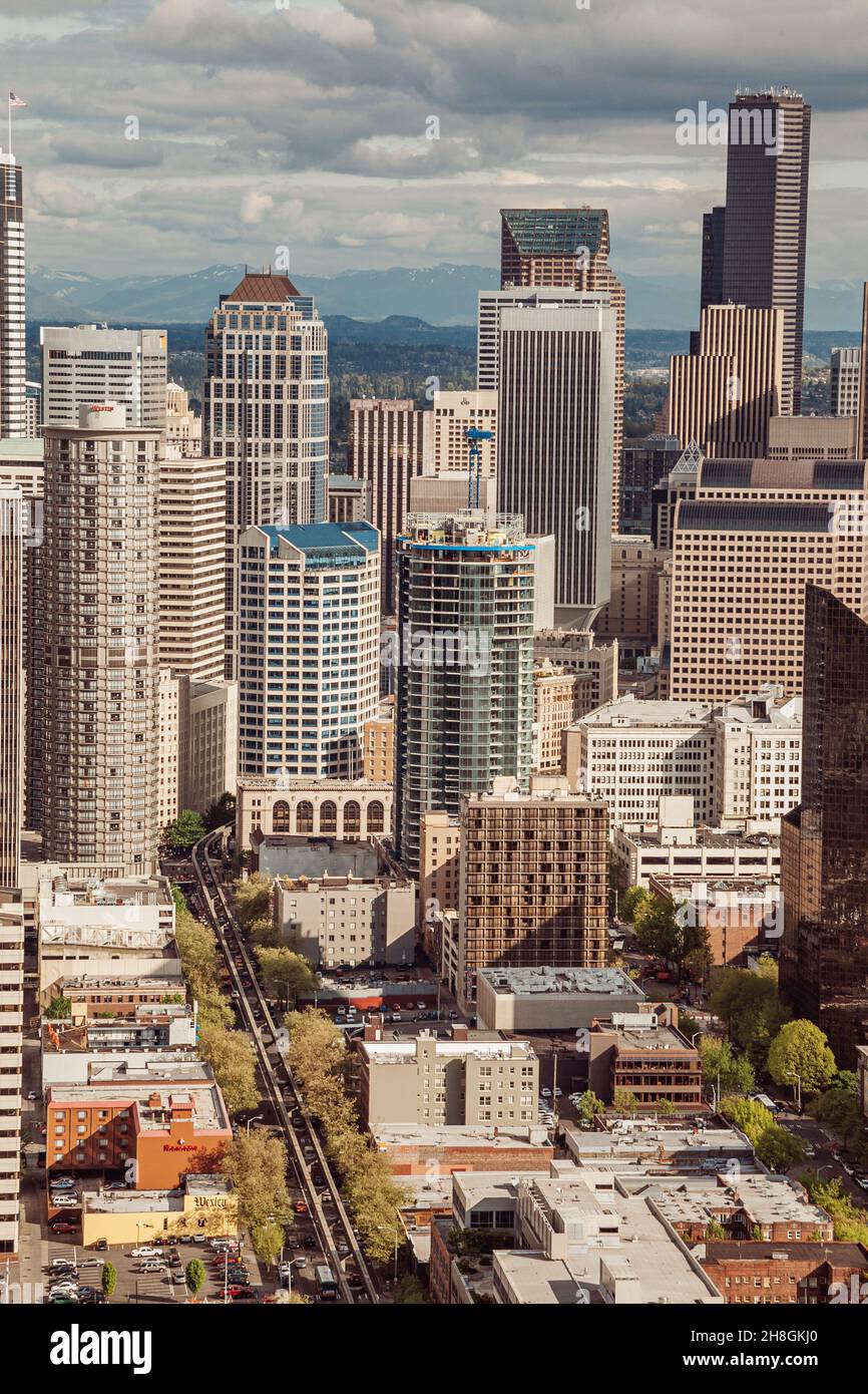 Vertical shot of Seattle skyscrapers with clouds and blue sky on the ...