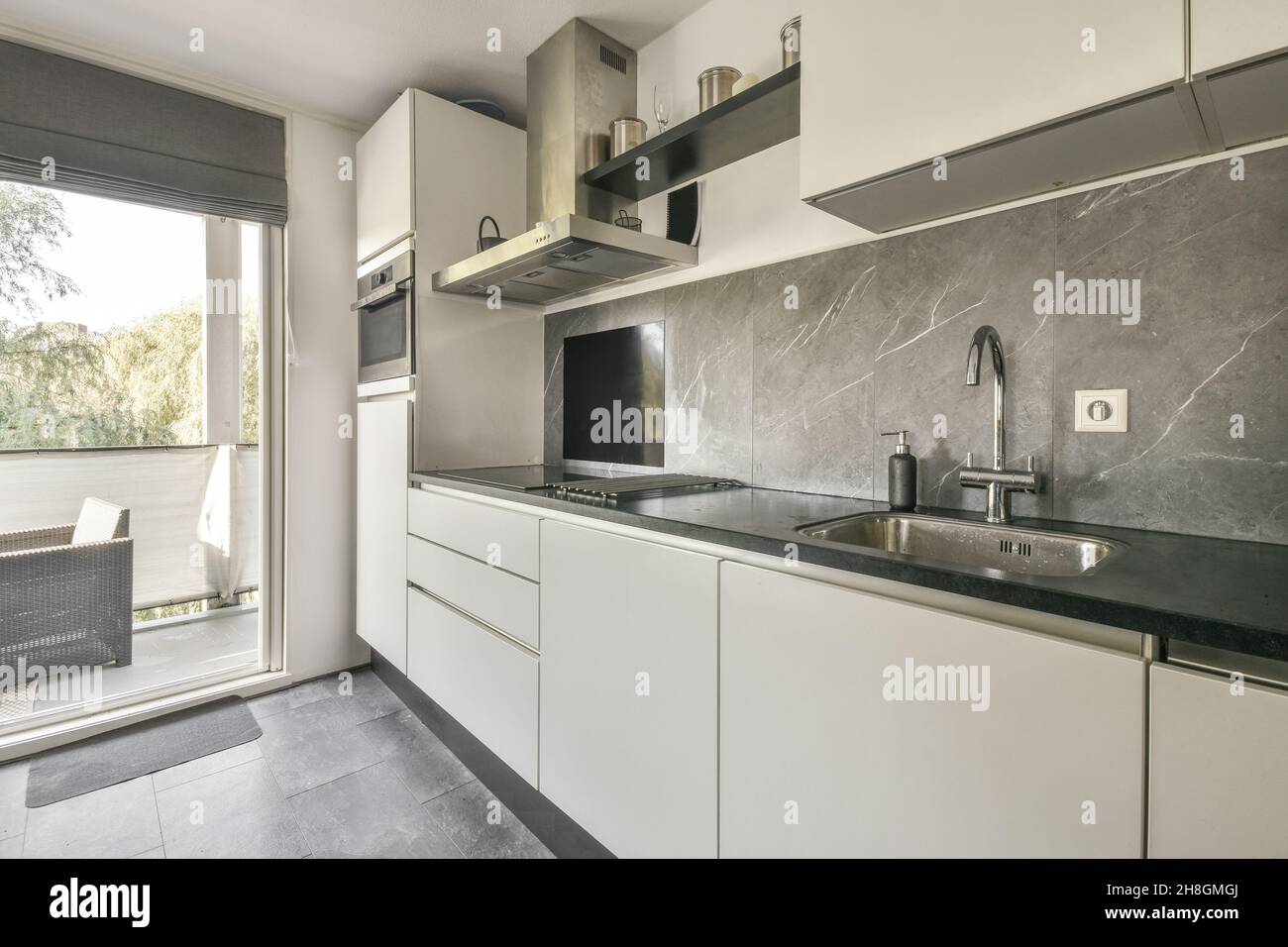 Luxury kitchen in shades of gray with a worktop and high-legged chairs ...