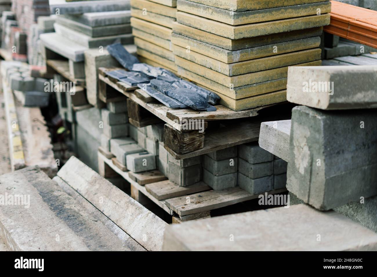 Large sectional sewer pipes, bricks, paves in a warehouse construction ...