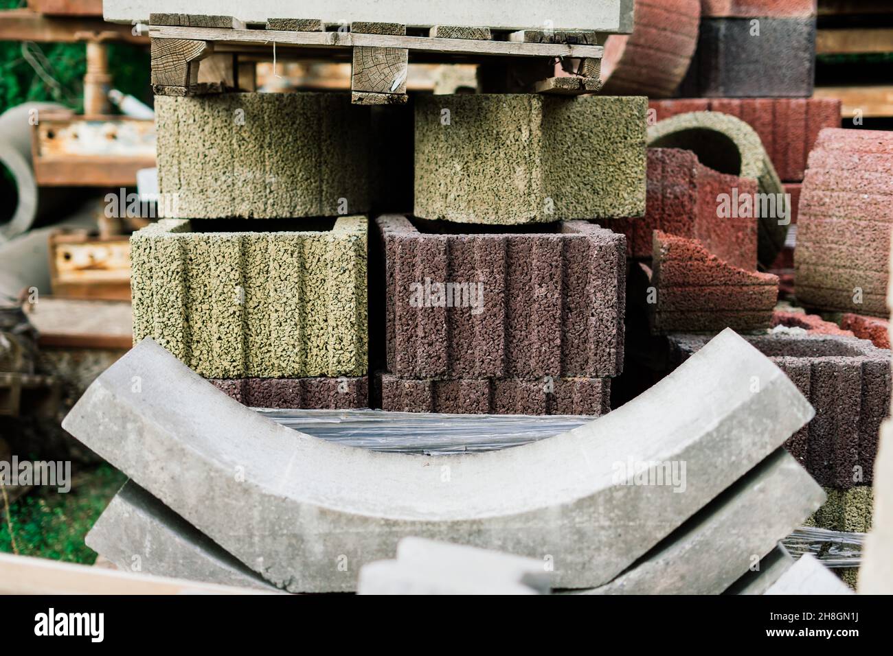 Large sectional sewer pipes, bricks, paves in a warehouse construction ...