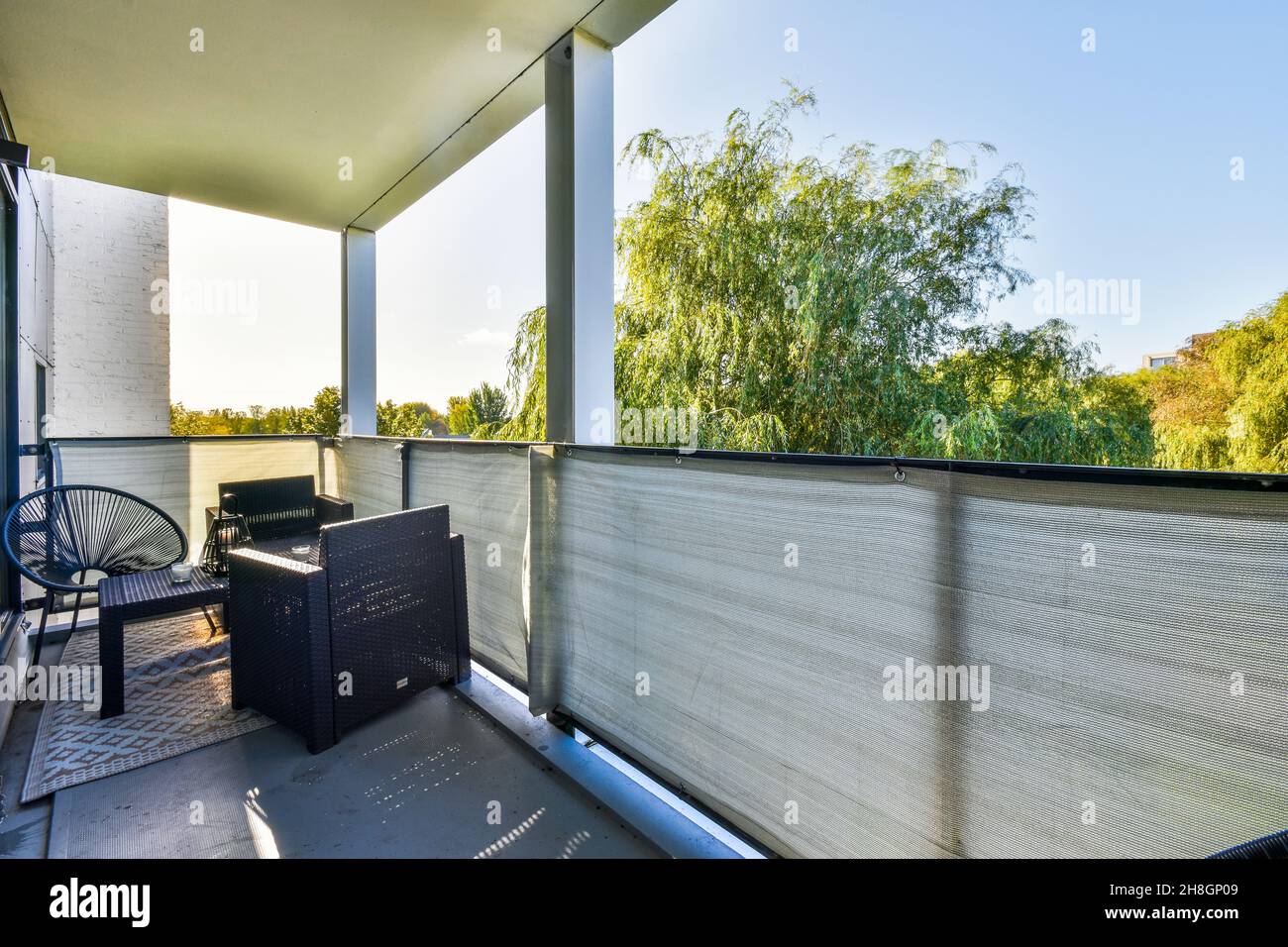 Luxurious balcony with wicker chairs and coffee table Stock Photo - Alamy