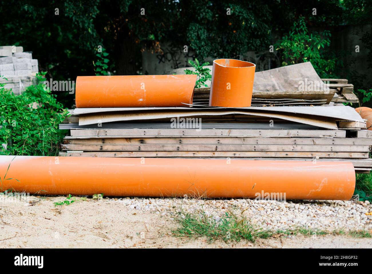 Large sectional sewer pipes, bricks, paves in a warehouse construction ...
