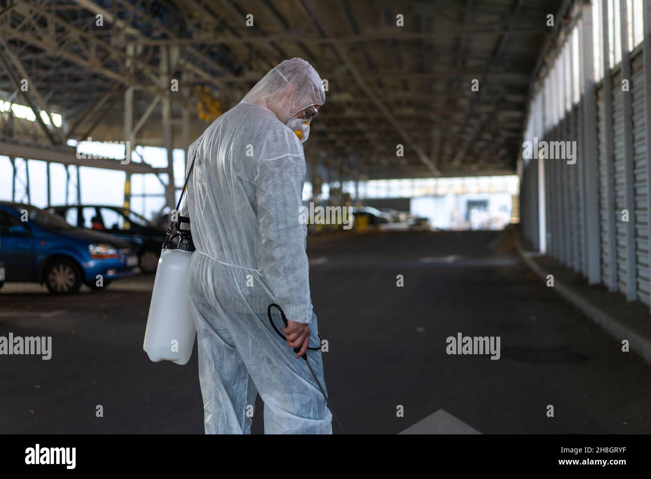 Worker wearing protective suit disinfection gear disinfect surface ...