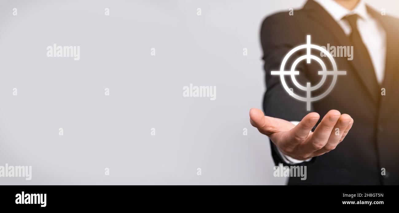 Targeting concept with businessman hand holding target icon dartboard ...