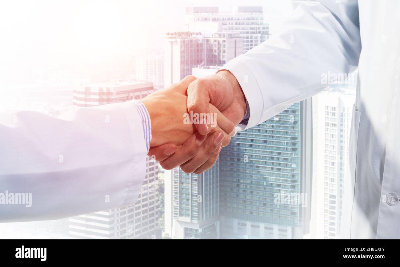 Close-up of the handshake between the two medics Stock Photo - Alamy