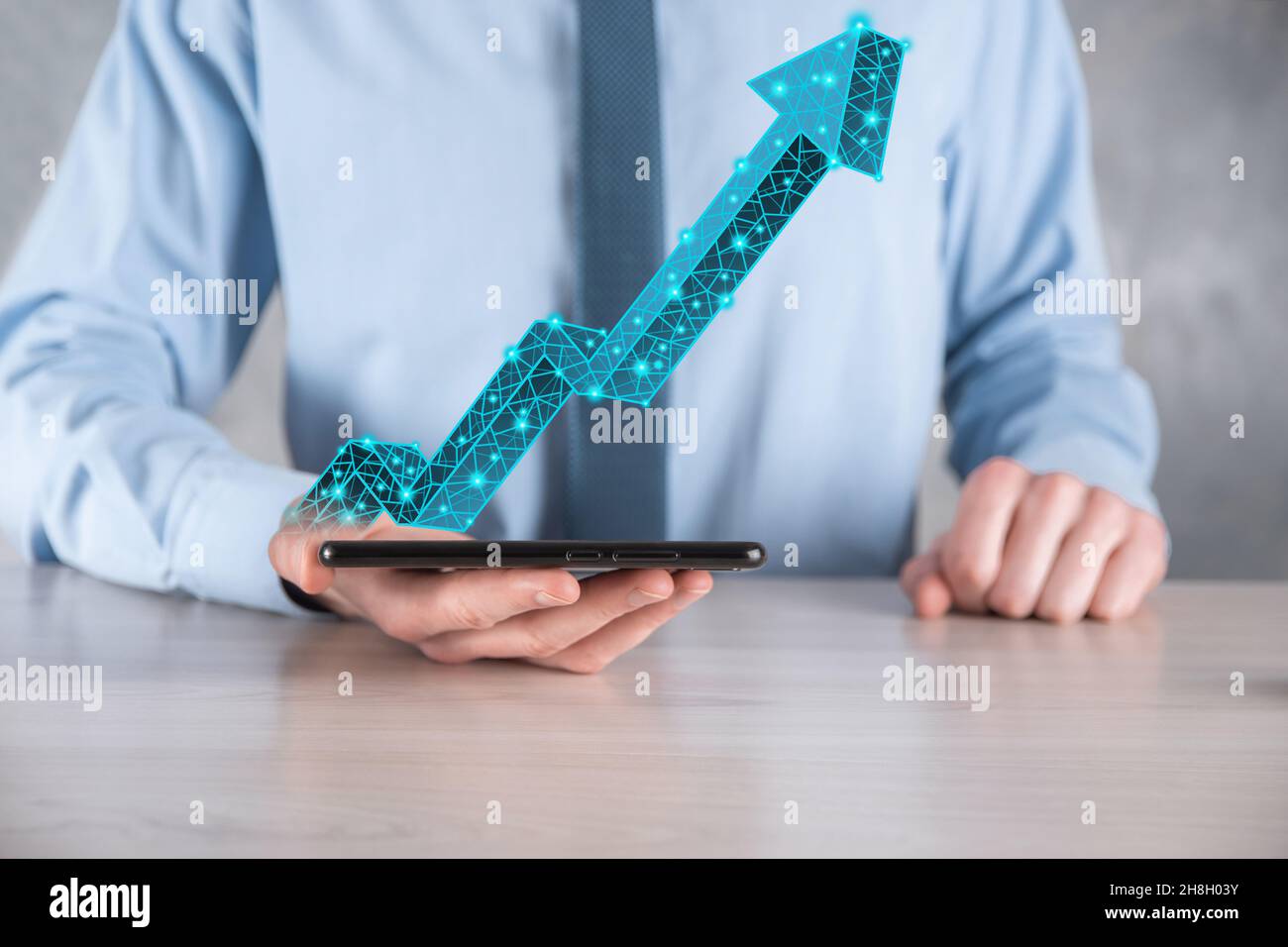 Businessman hold graph, arrow of positive growth icon.pointing at ...