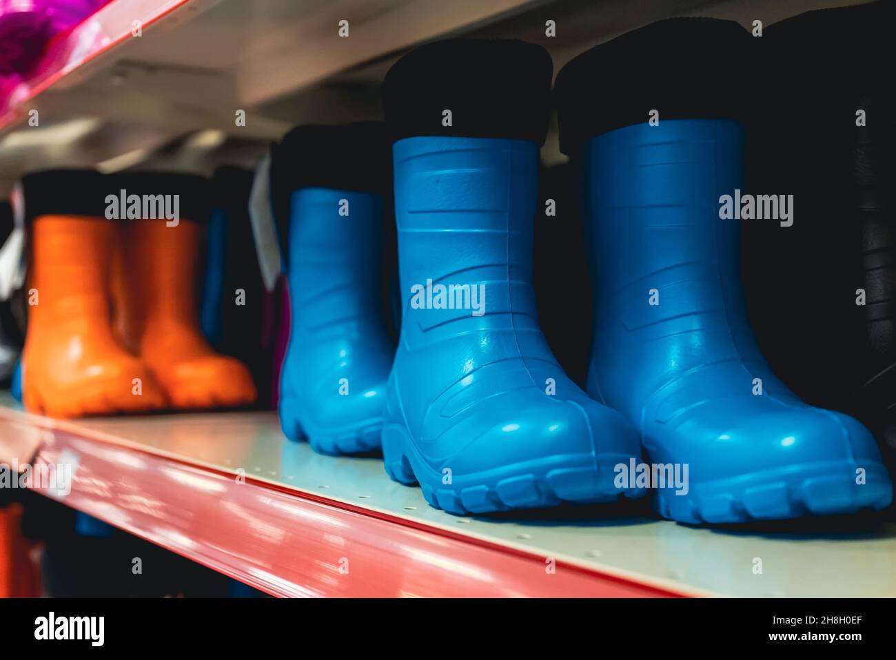 Collection of rubber boots in a clothing store Stock Photo - Alamy