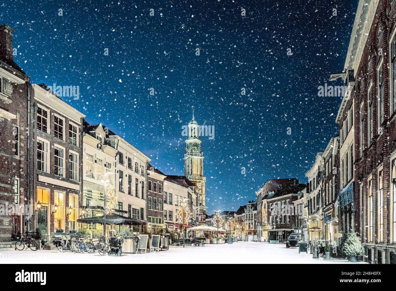 Winter view of bars and restaurants with christmas lights on the ...