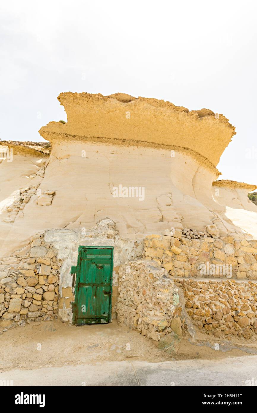 Rock cut room with green door at the salt pans, Gozo Stock Photo - Alamy