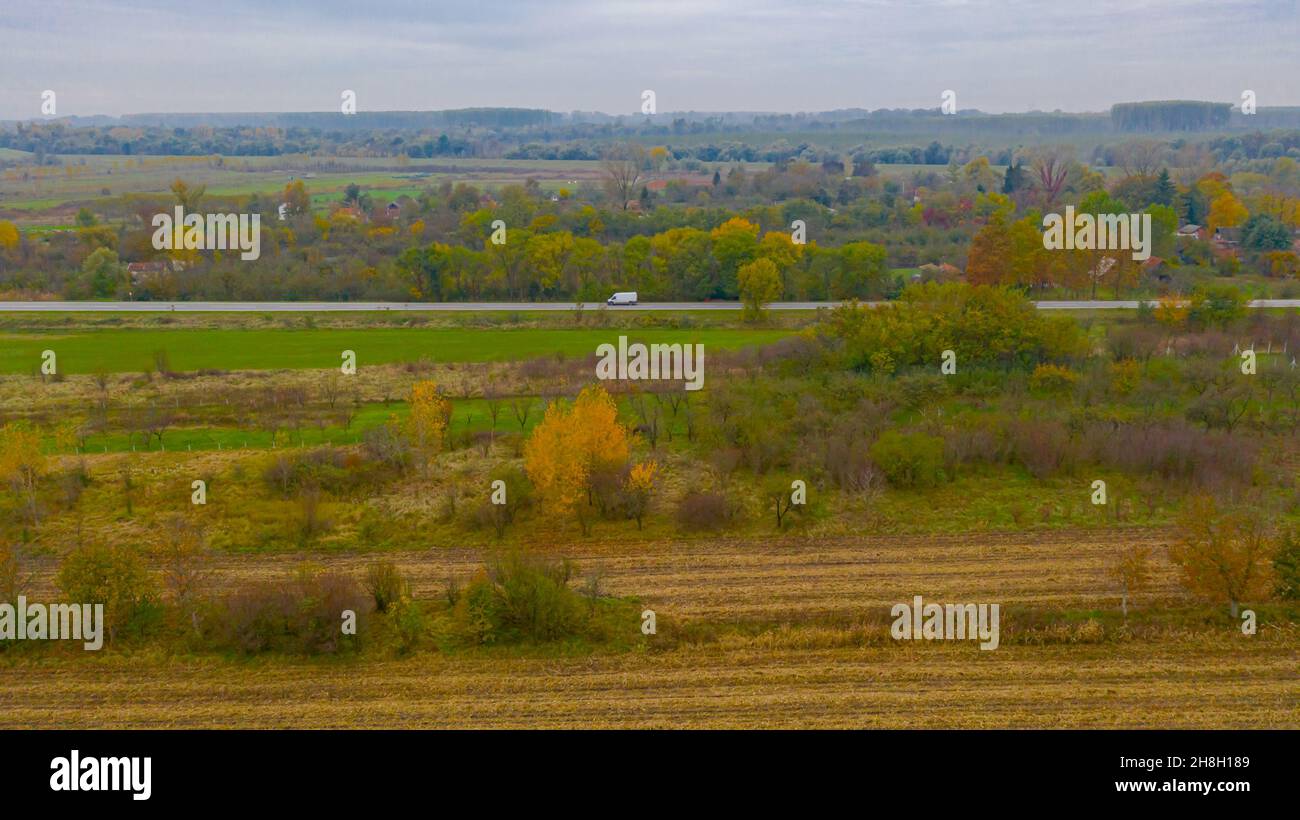 Above top view, haze over horizon, landscape vegetation, asphalt road ...