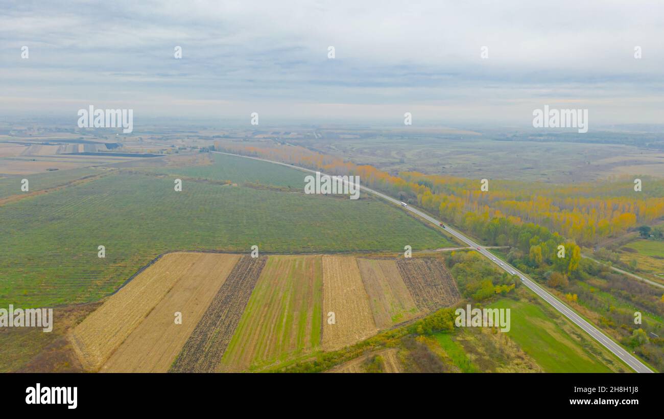 Above top view, haze over horizon, landscape vegetation, curve asphalt ...