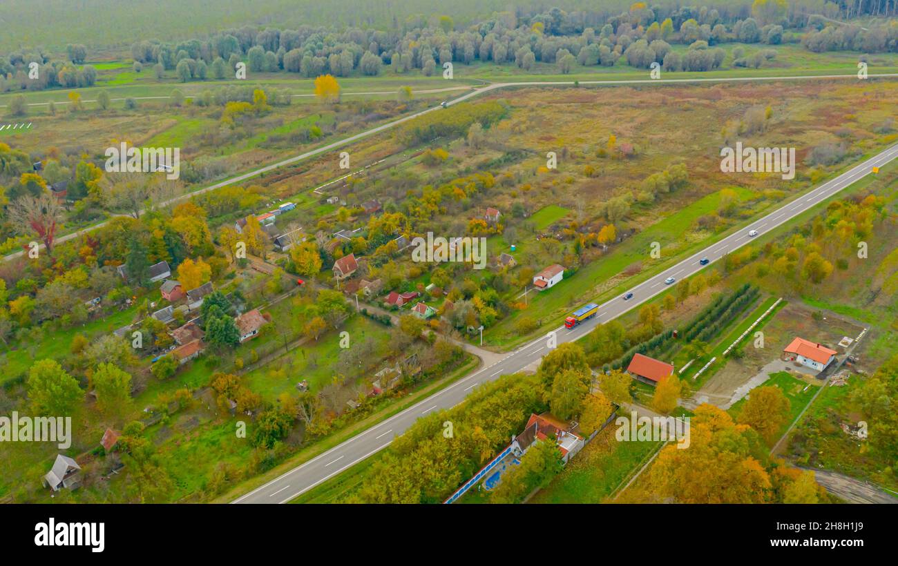 Above view of haze, over landscape vegetation and asphalt road that is ...