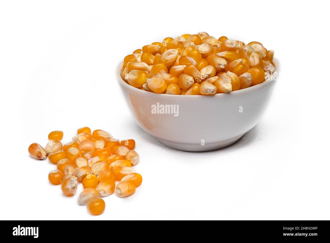 Heap of sweet corn kernels on a white background Stock Photo - Alamy