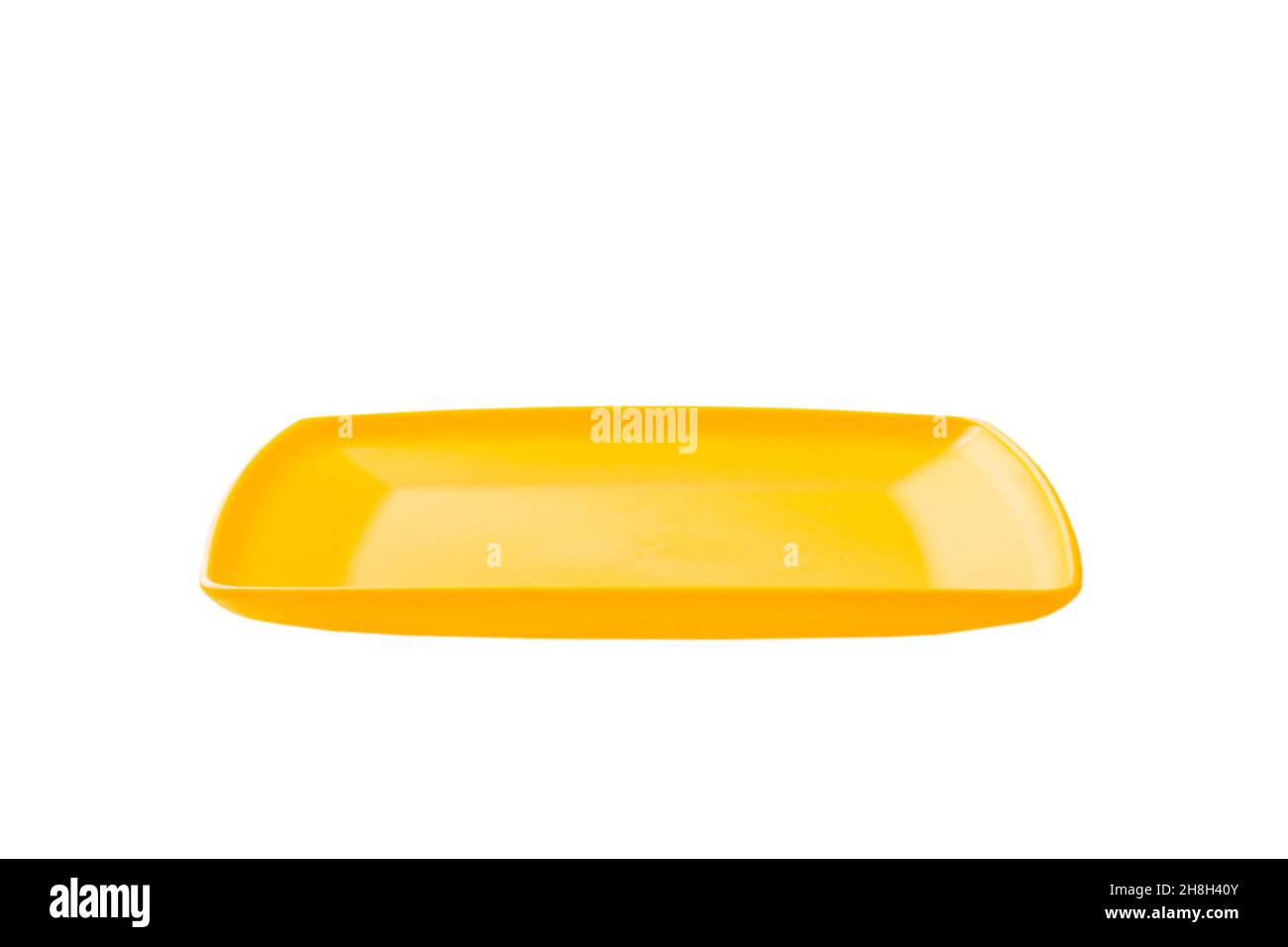 yellow plastic square plate isolated over white background. perspective ...
