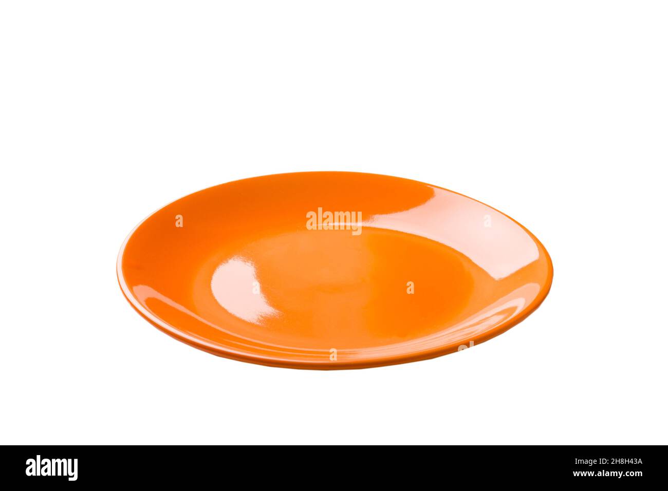 Orange ceramic round plate isolated over white background. perspective ...