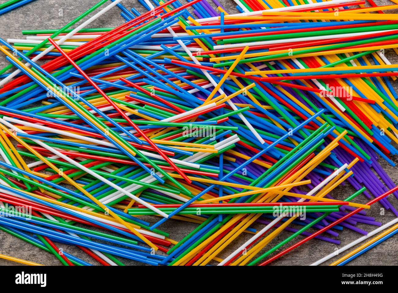 many multi-colored plastic tubes for cocktail on Colored background ...