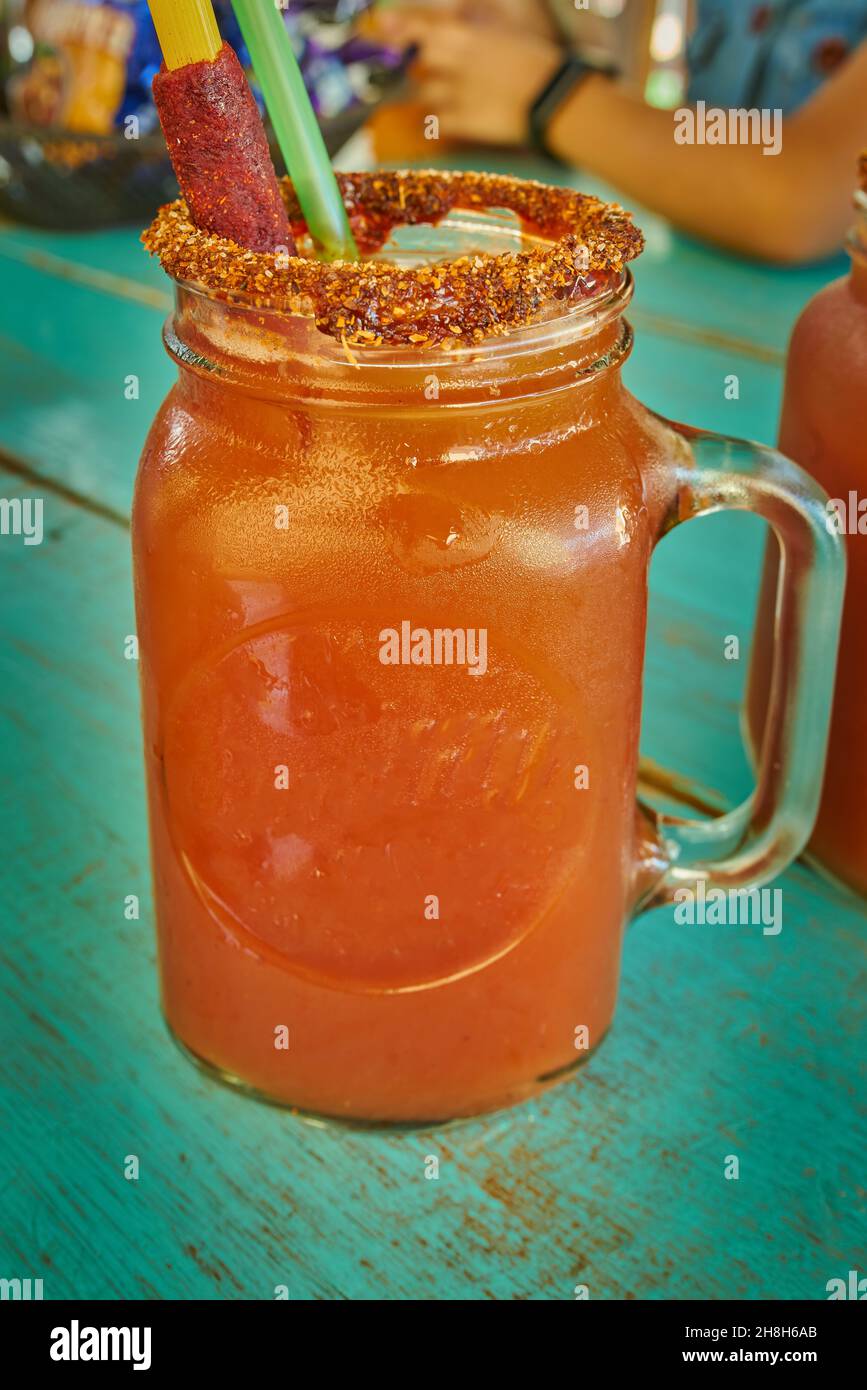 Michelada served in mason glass with tamarind candy garnish Stock Photo ...