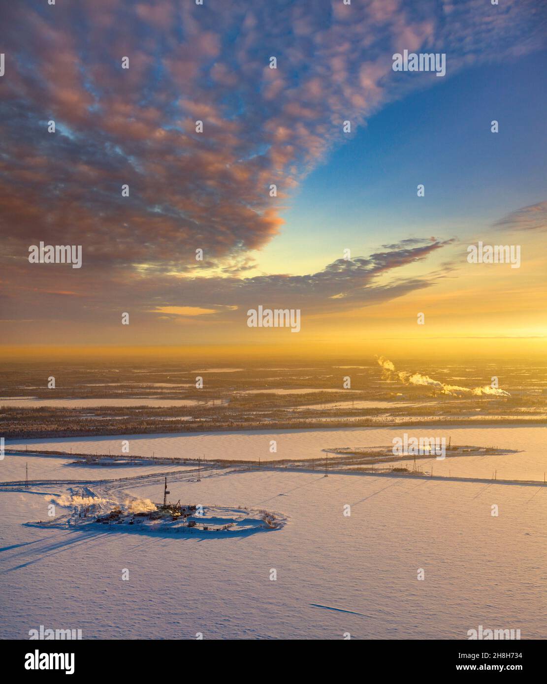 Air photo of oil field on Samolor lake during frosty winter evening in ...
