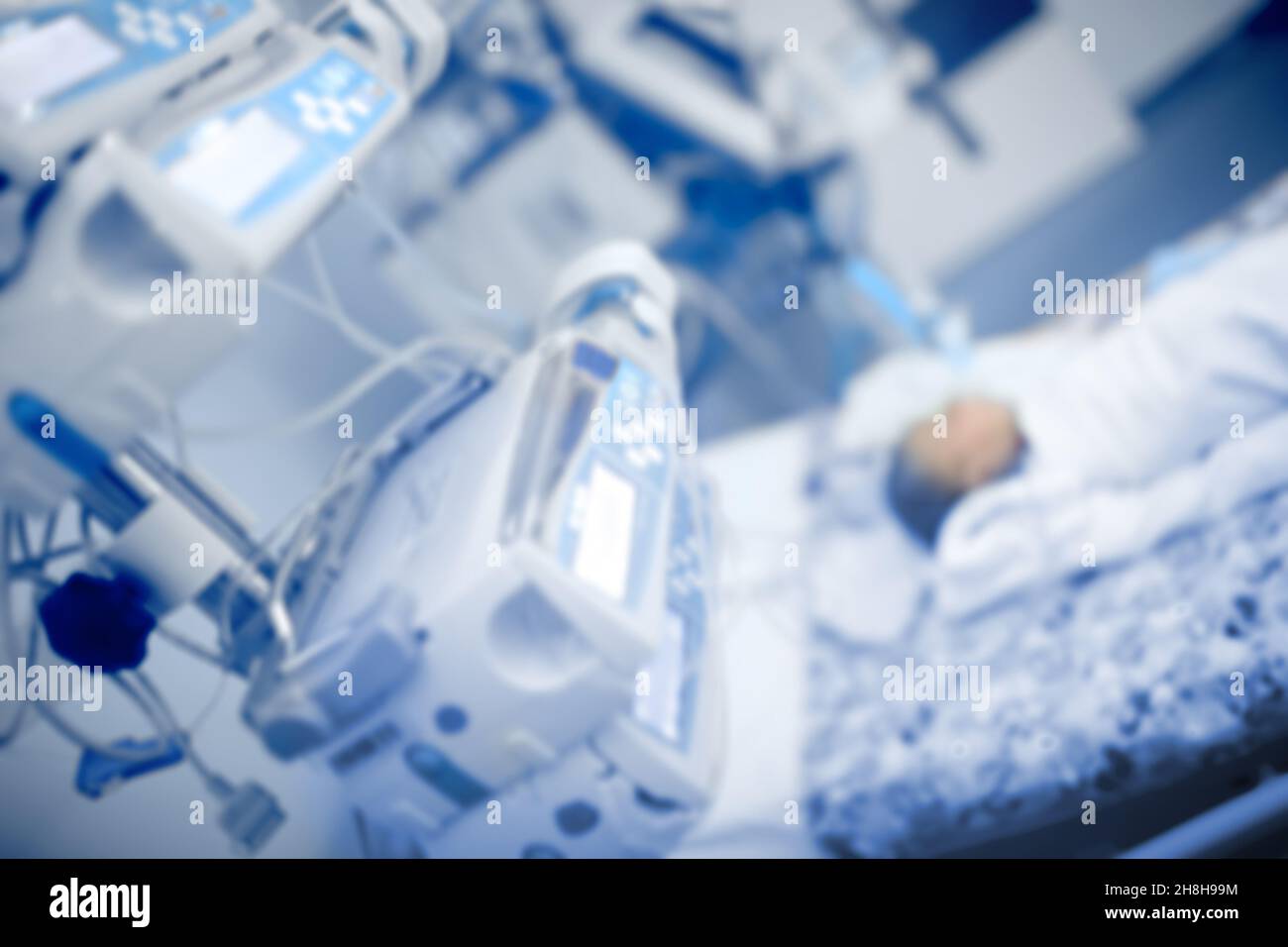 Newborn baby lying in the bed connected to the life support system in ...