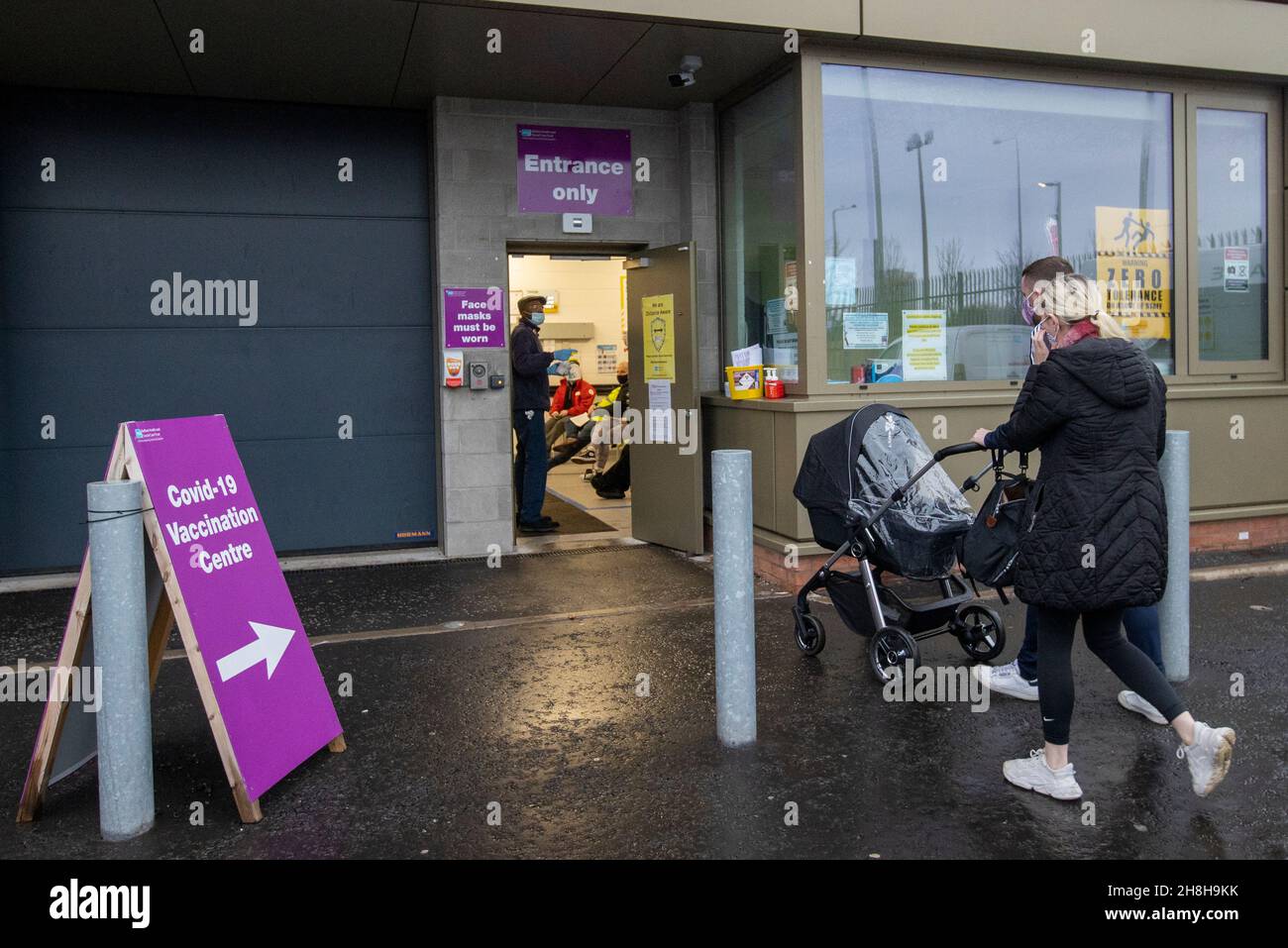 A couple with a young child walk into the Belfast Health and Social ...