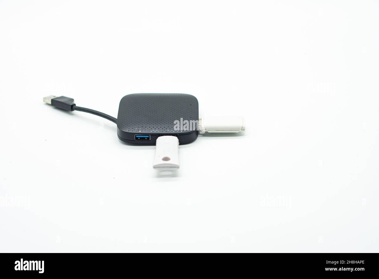 External USB hub and usb flash drives on white background Stock Photo ...