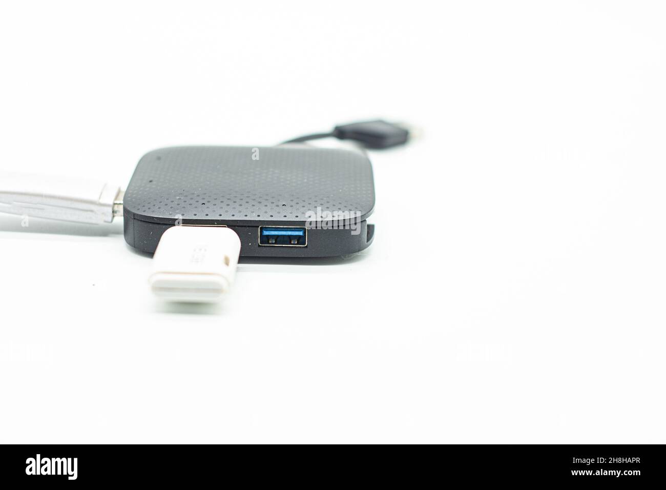 External USB hub and usb flash drives on white background Stock Photo ...