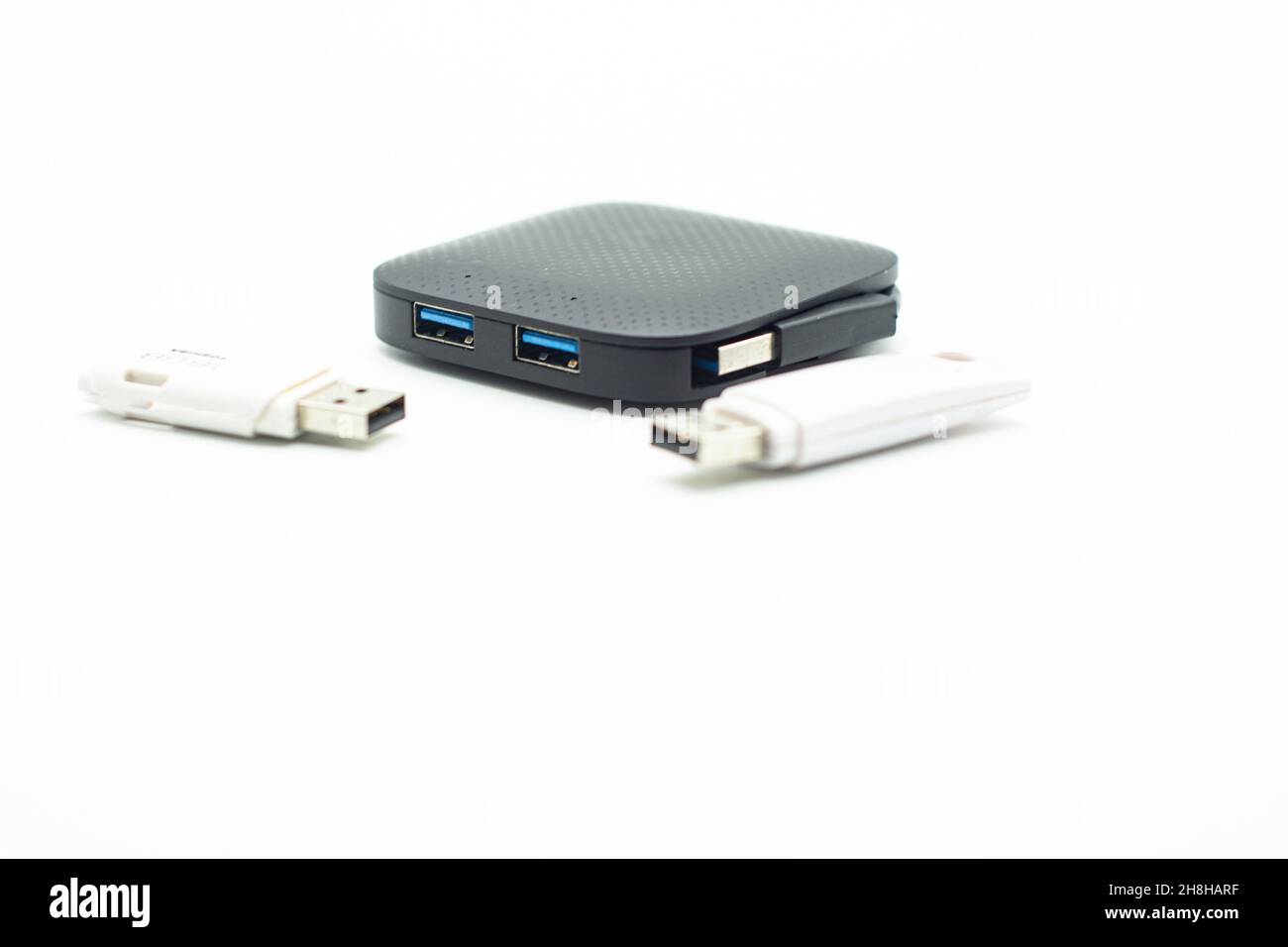 External USB hub and usb flash drives on white background Stock Photo ...
