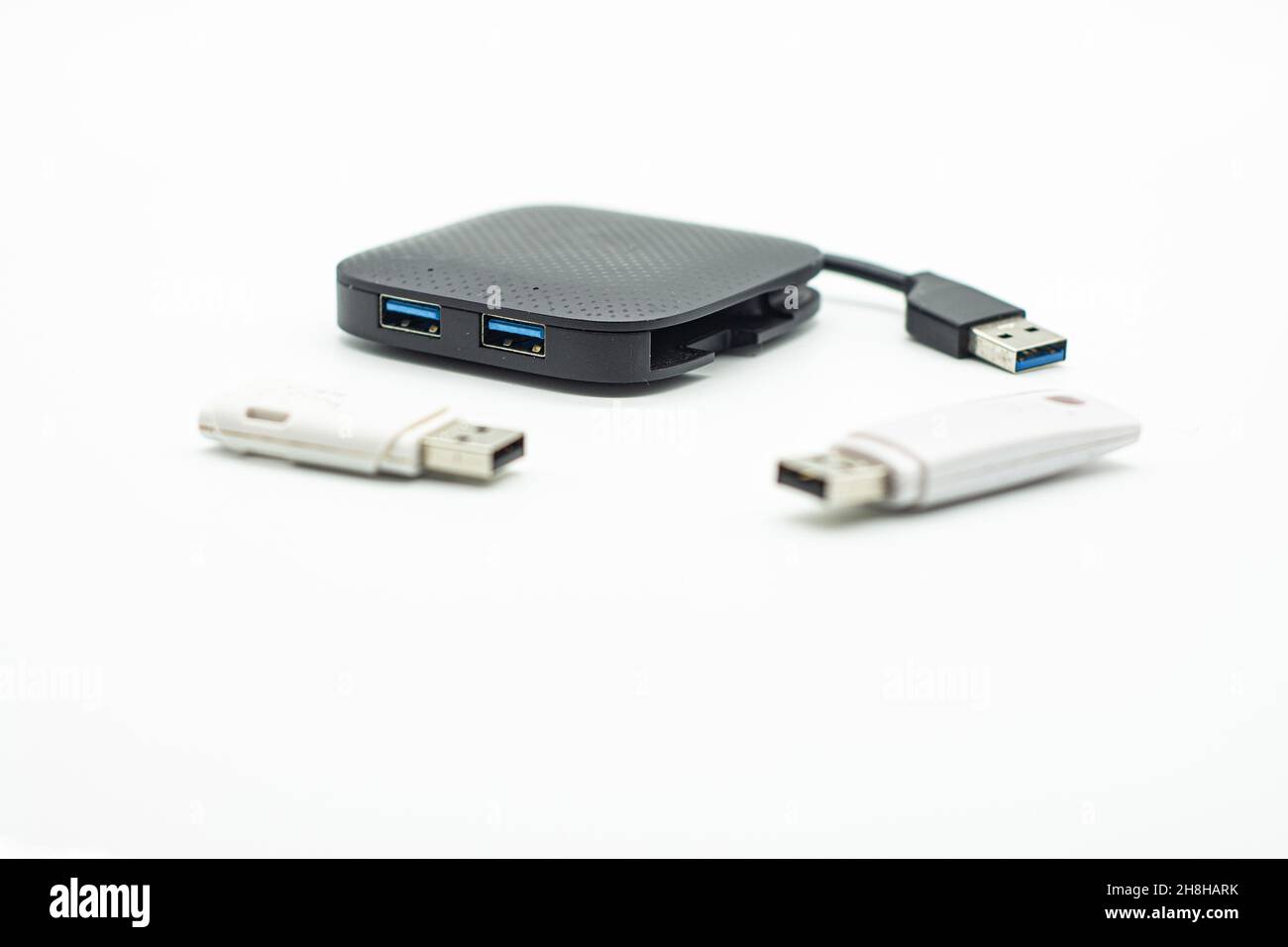 External USB hub and usb flash drives on white background Stock Photo ...