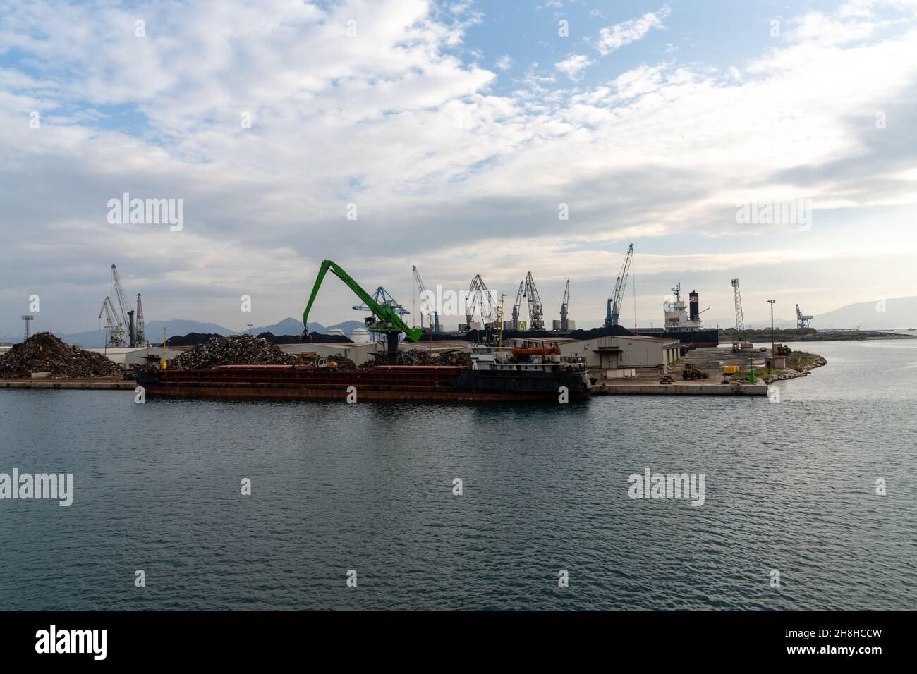 Ploce, Croatia - 18 November, 2021: harbor crane unloading scrap metal ...