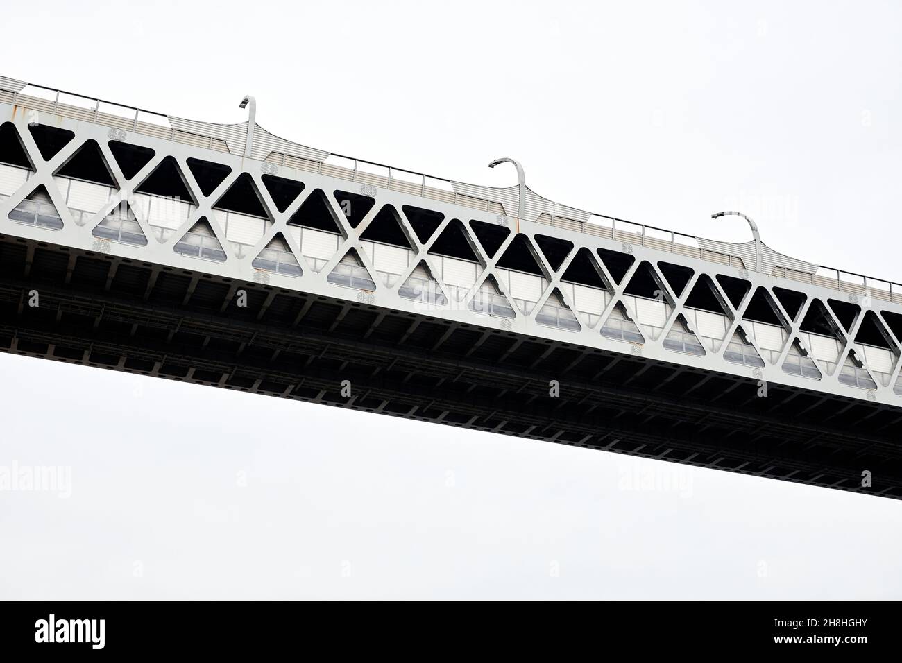 Minimal background image of high tech metal bridge against white sky ...