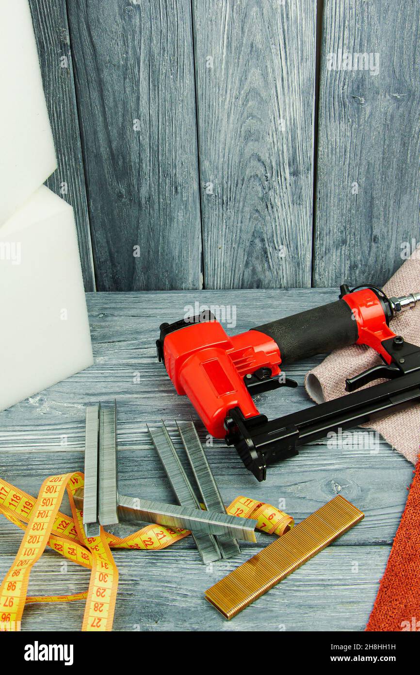 concept of furniture production and repair. Stapler and staples ...