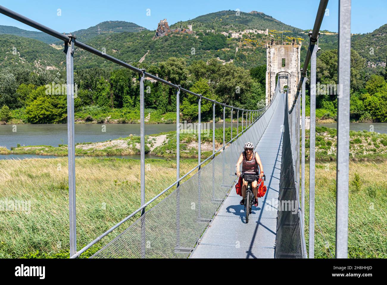 France, Ardeche, ViaRhôna, Rochemaure, cyclist crossing the Rochemaure ...