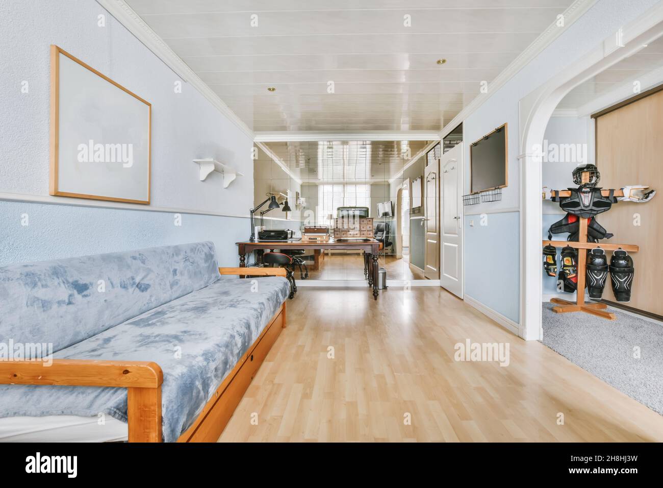 Large cozy room with a sofa, a table and a comfortable black armchair ...