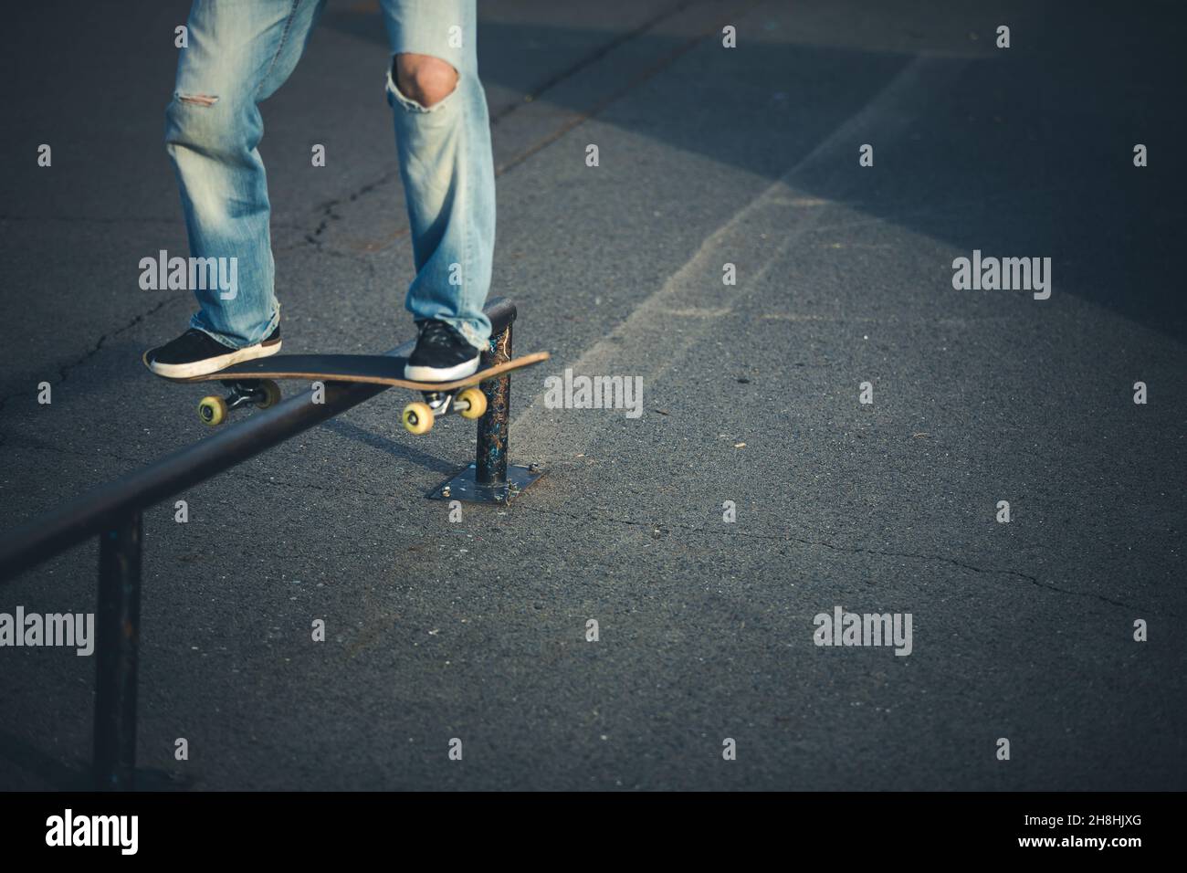 Skateboarder riding fast towards the ramps to be lifted into the air ...