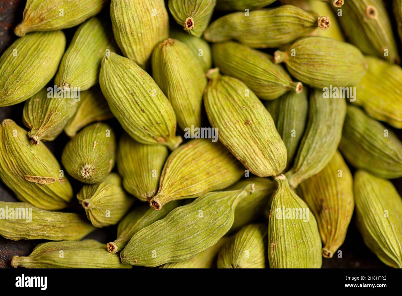dried cardamom food background close up, top view Stock Photo - Alamy